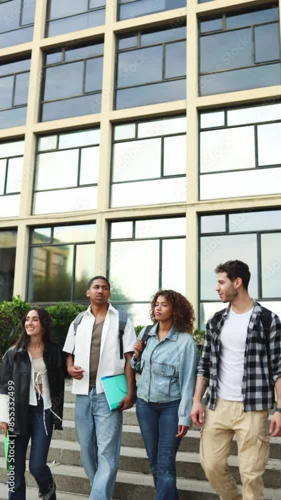 Diverse students walking and talking outside a modern campus building ...