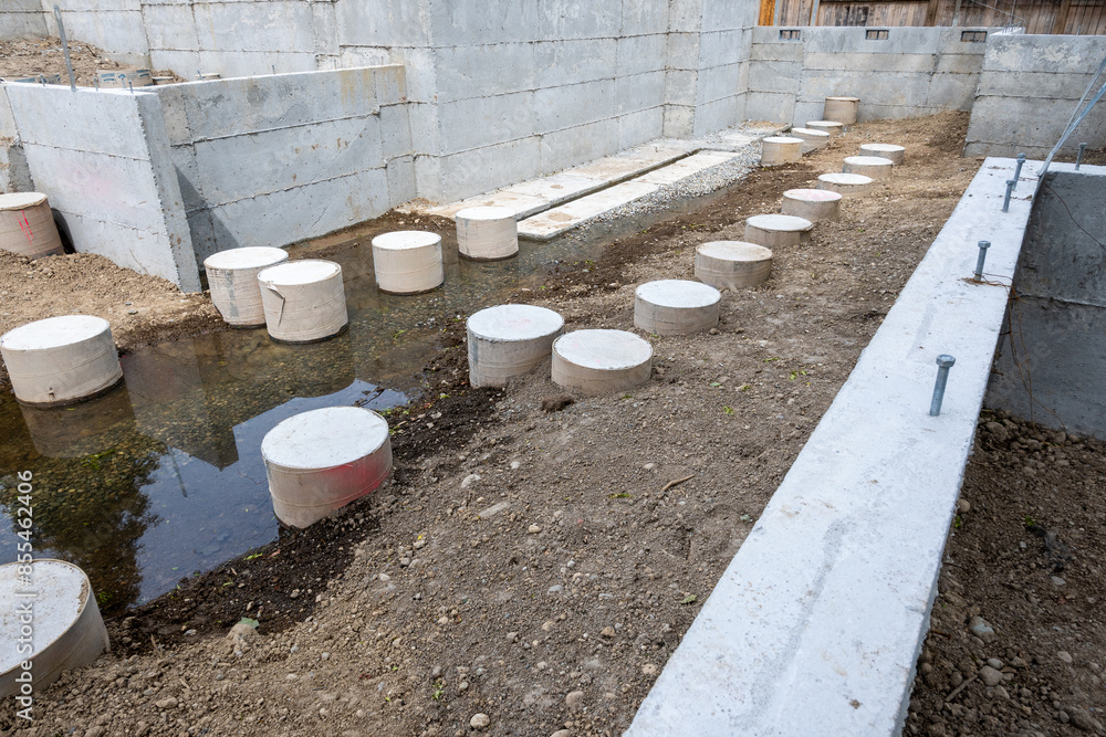 New home foundation construction in progress, cement retaining walls in ...