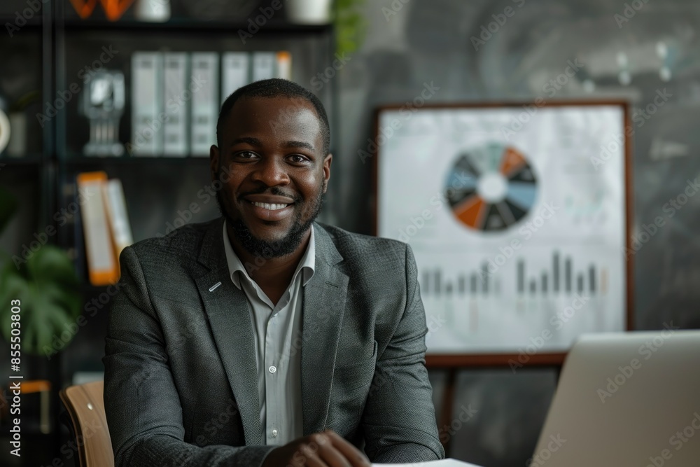 A successful entrepreneur in a modern office, holding a framed ...