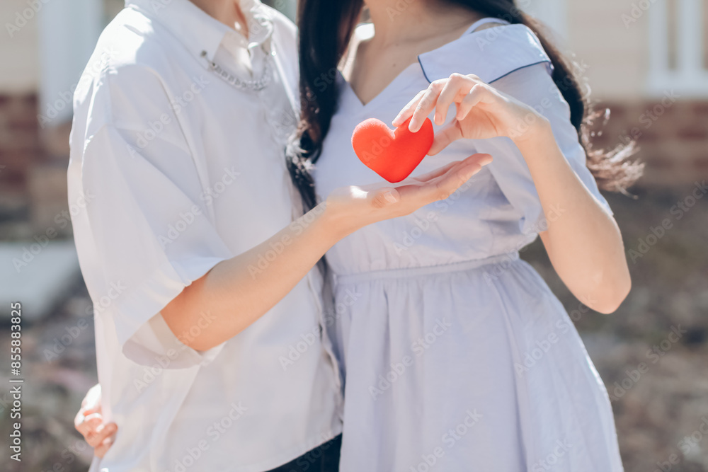 Couples display heart shaped symbols together to show their love and ...