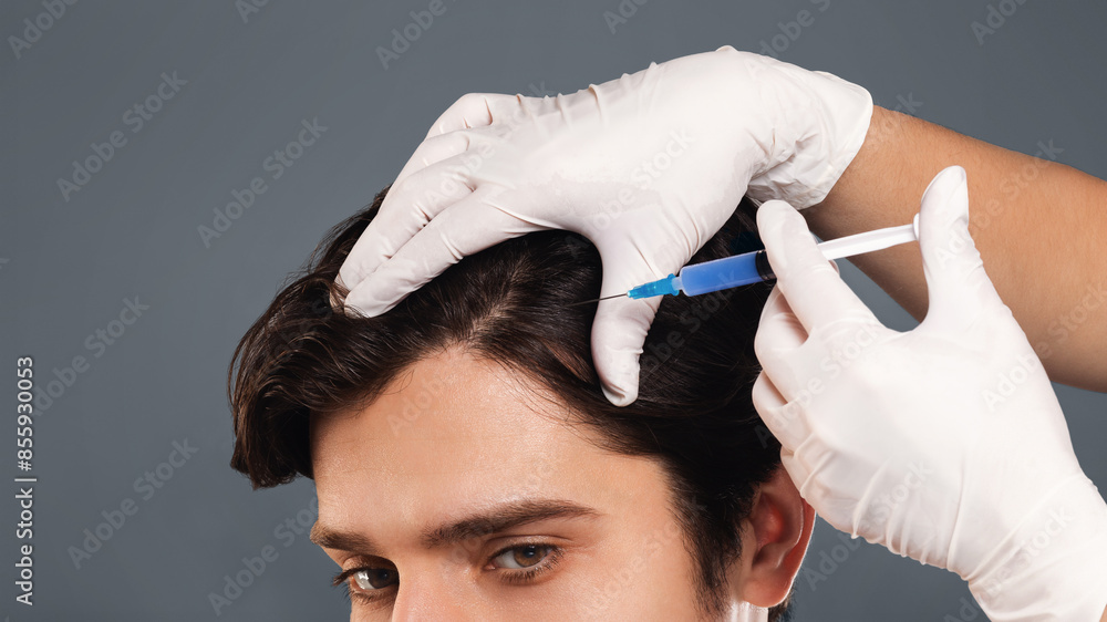 Mesotherapy of hair. Young man getting injections in head, grey ...