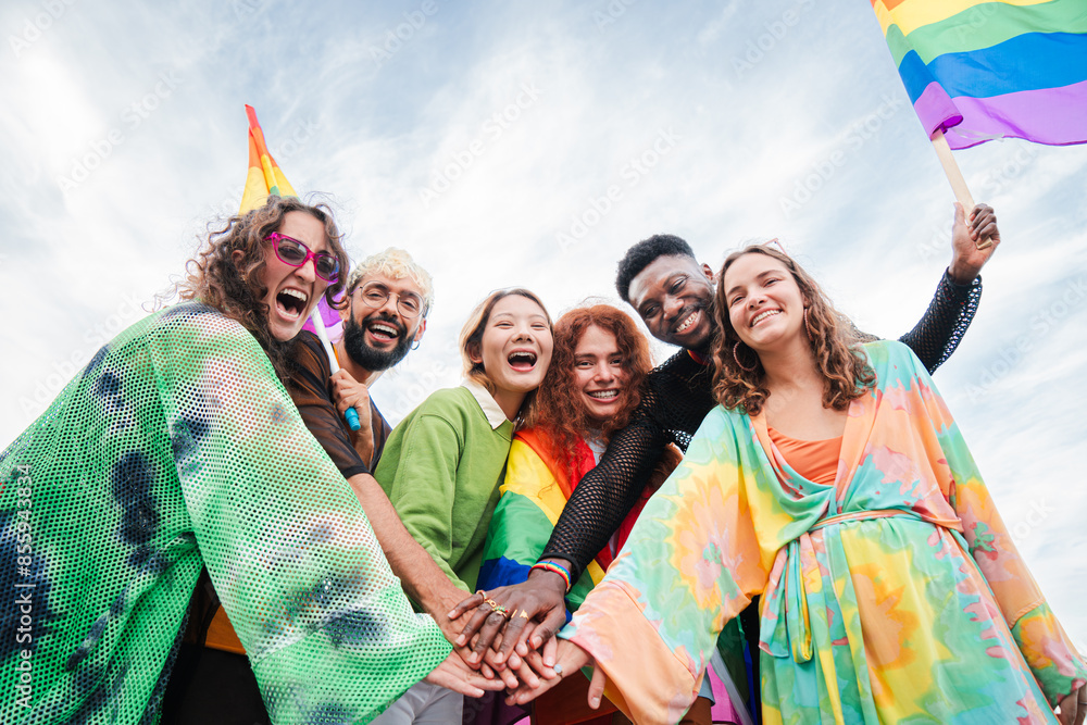 Group of LGBT young people stacking hands on a a gay pride parade ...
