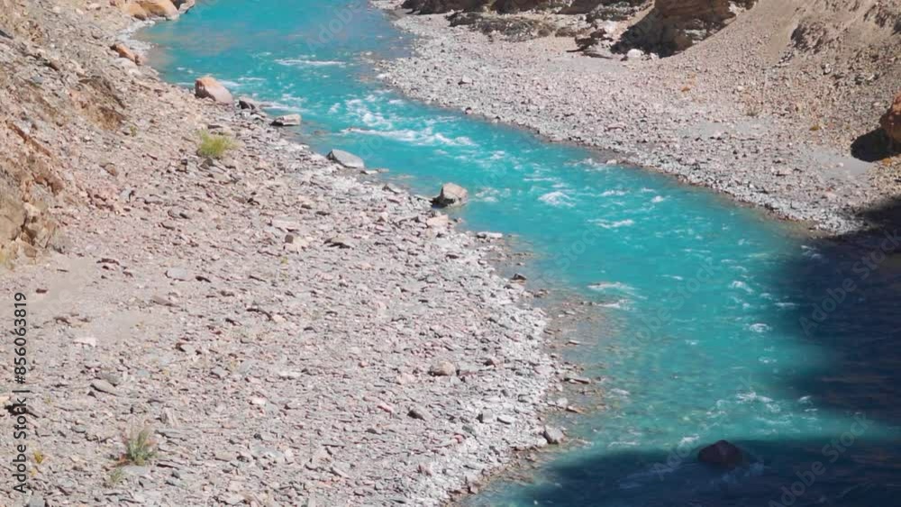 Closeup shot of blue colored Tsarap Chu river flowing in the remote ...