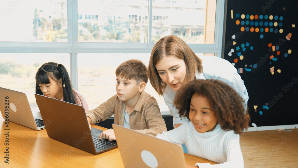 African girl play laptop with diverse friend learning prompt at STEM technology class ...