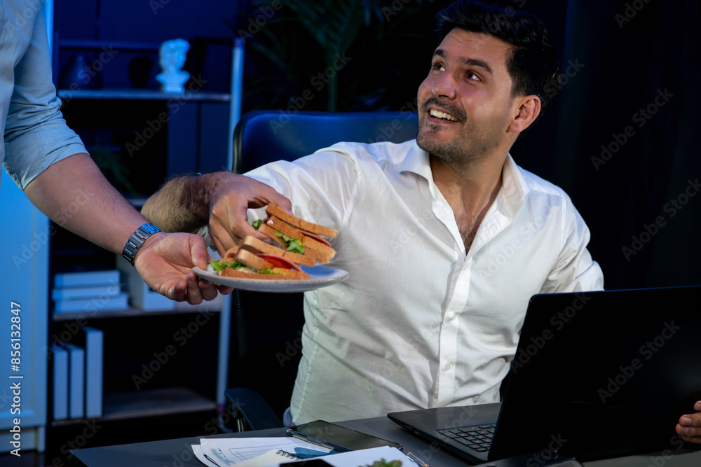 Coworker partners with happy smiling face sharing delicious sandwich ...