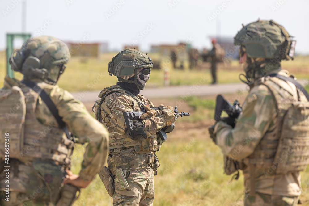 Army soldier with a machine gun in his hand. Soldier, commando stands ...