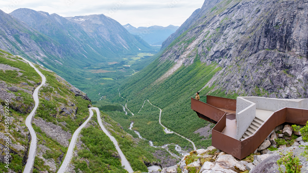 A scenic overlook provides a stunning view of a winding road snaking ...