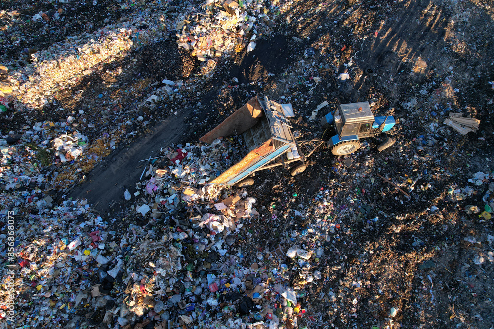 Landfill garbage truck. Garbage truck unloads rubbish in landfill ...