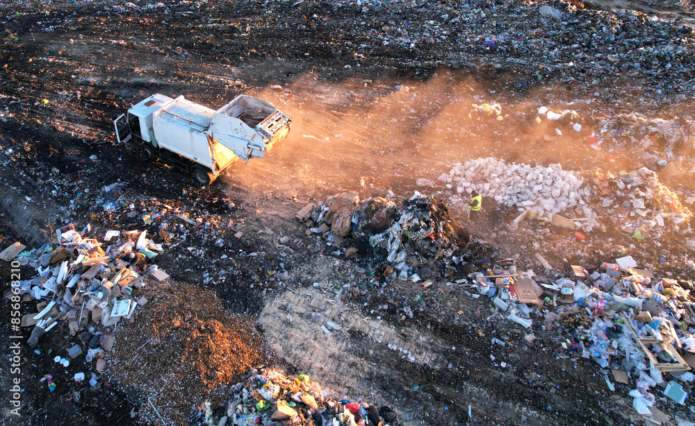 Landfill garbage truck. Garbage truck unloads rubbish in landfill ...