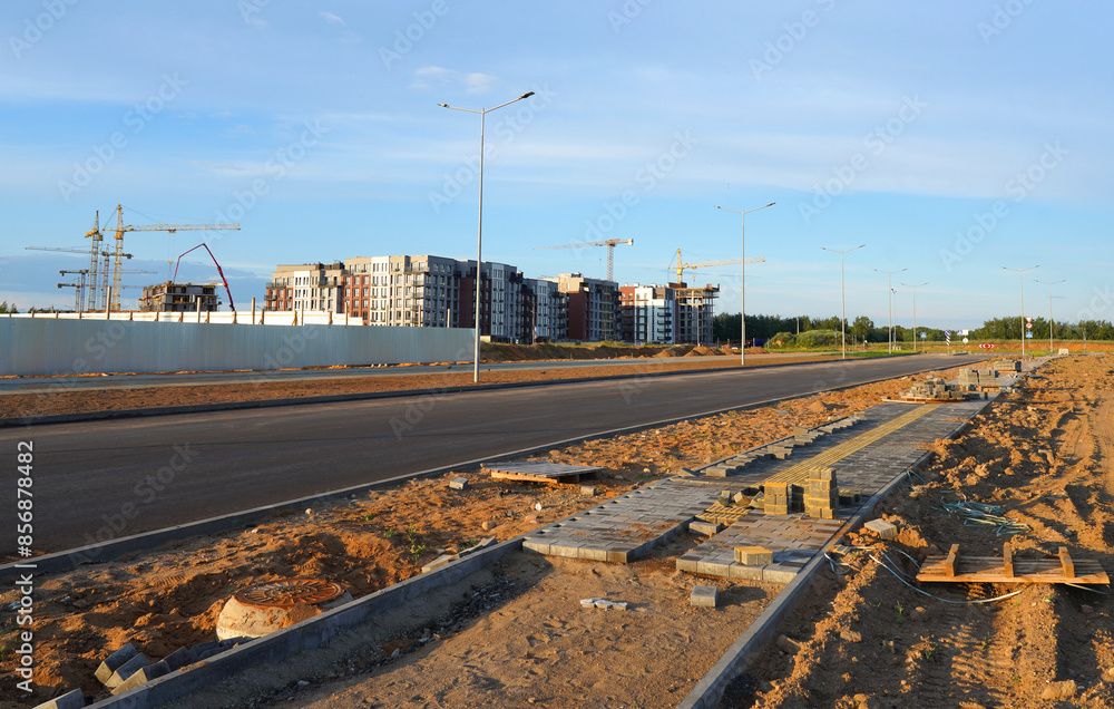 Sidewalk Tiles Laying. Laying Paving Slabs on construction site. Stone ...