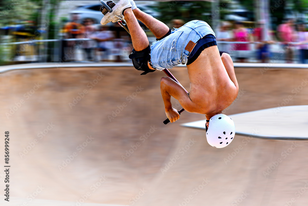Young man practicing Scootering (Freestyle Scootering) in the new ...