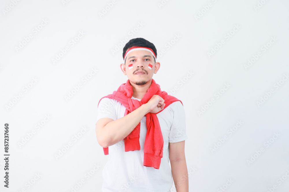 Smiling happy young Asian man giving salute gesture with hands on his ...