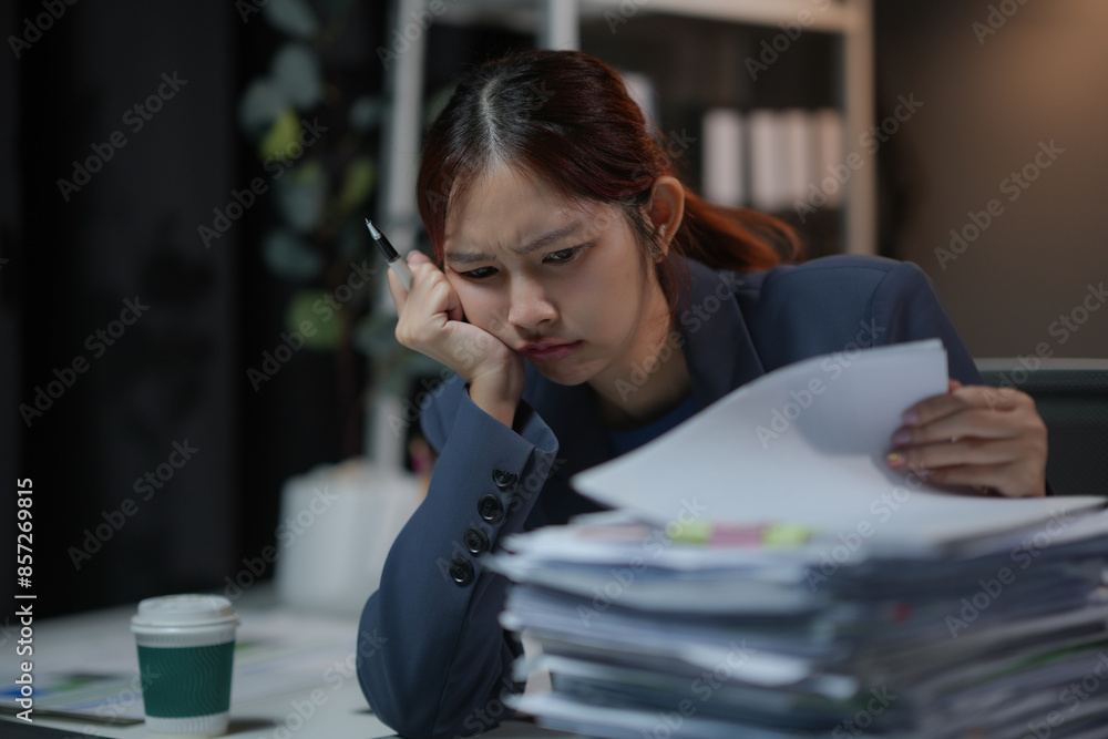 Stressed office worker in a dark office, overwhelmed by paperwork. Long ...