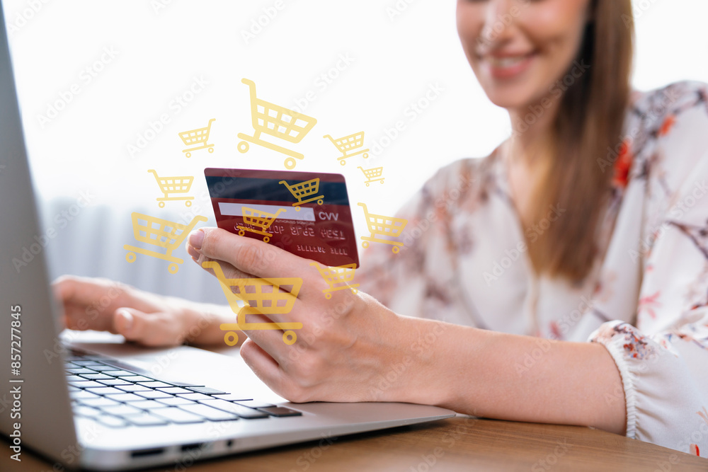 Elegant customer wearing floral shirt holding credit card typing laptop ...