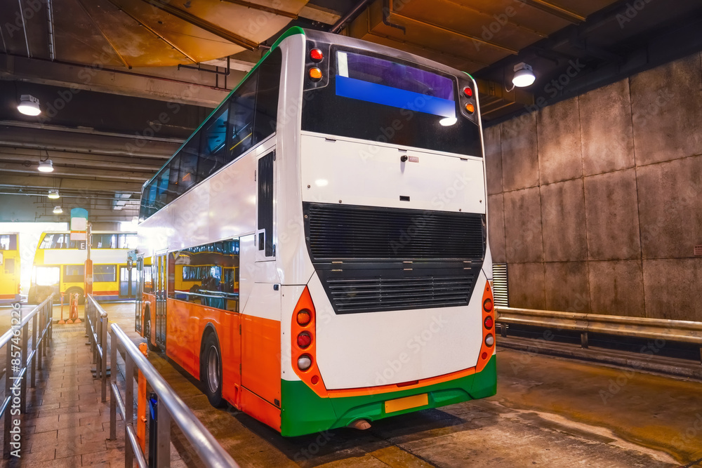 Double-decker city shuttle bus at an stopped at stop to drop off pick ...