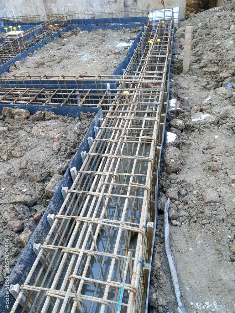 Strip foundation with rebar reinforcement in construction site. Vertical shot for structural ...