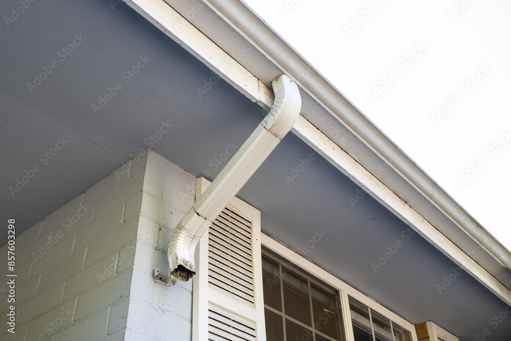 Rectangular white metal rainwater downspout detached from mounting ...