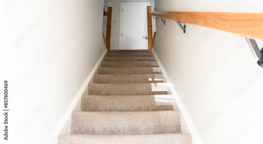Low angle view of Staircase in the modern house with brown carpet and ...