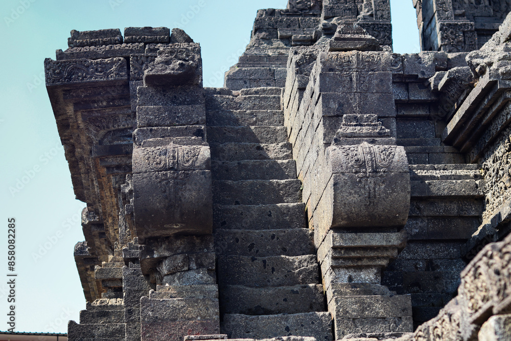 staircase at jago temple, adorned with intricate relief carvings ...
