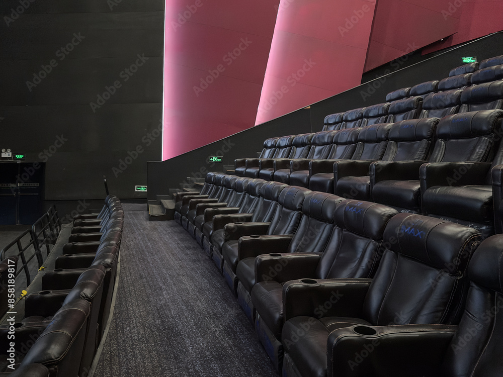This image captures an empty IMAX cinema hall with multiple rows of ...