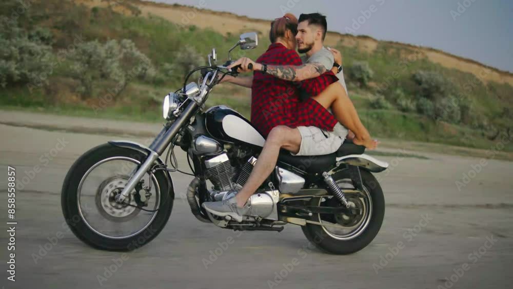 A romantic couple embraces the freedom of riding a motorcycle on the ...
