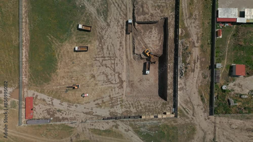 Construction site, foundation pit. Excavation, excavator pours earth ...