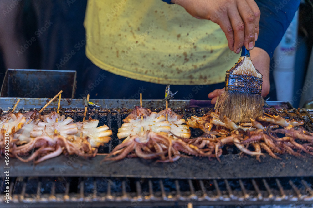 The photo showcases a mouthwatering grilled squid, cooked to perfection ...