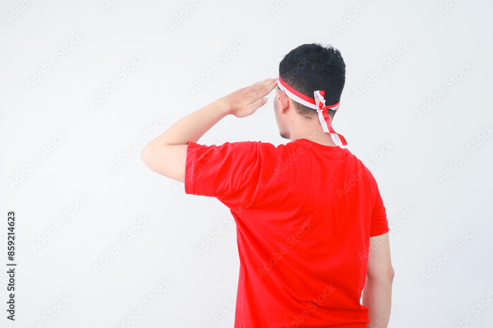 Back view young Asian man standing confidently giving a salute and ...