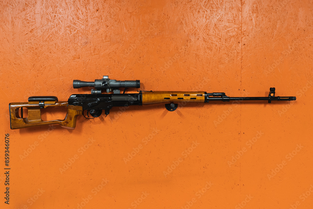 Russian sniper rifle SVD on an orange background at a shooting range ...