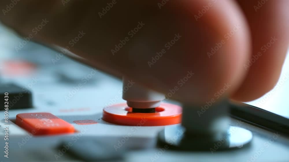 Man deftly presses and twists buttons on control panel in studio. Each ...