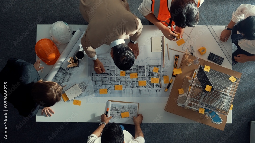 Top down view of skilled engineer team compare between blueprint and ...