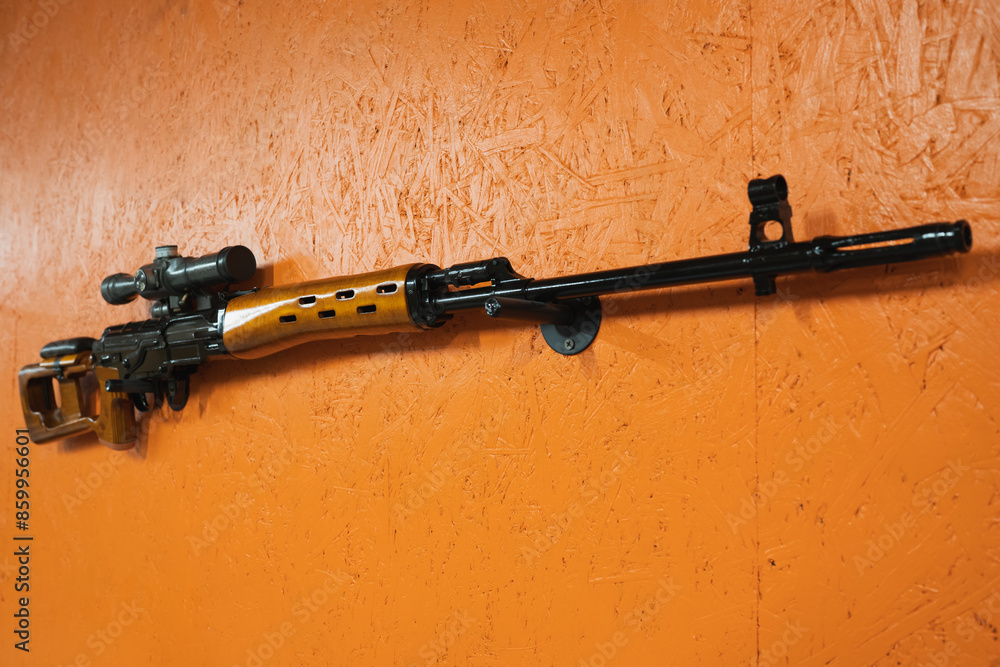 Russian sniper rifle SVD on an orange background at a shooting range ...