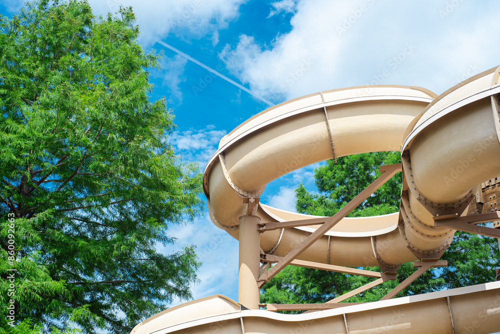 Tall tree and spiral water slide curved inline tube slides loop under ...