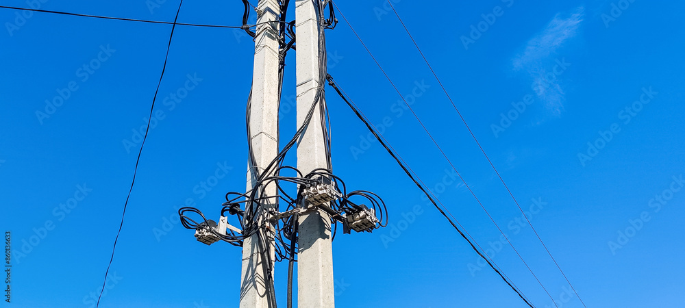 Concrete pillars with electrical wires, coils of cables and switching ...