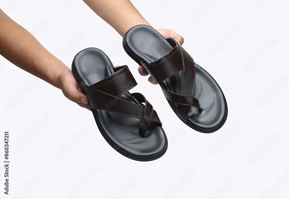 mens leather sandals hold in the hand isolated on white background ...