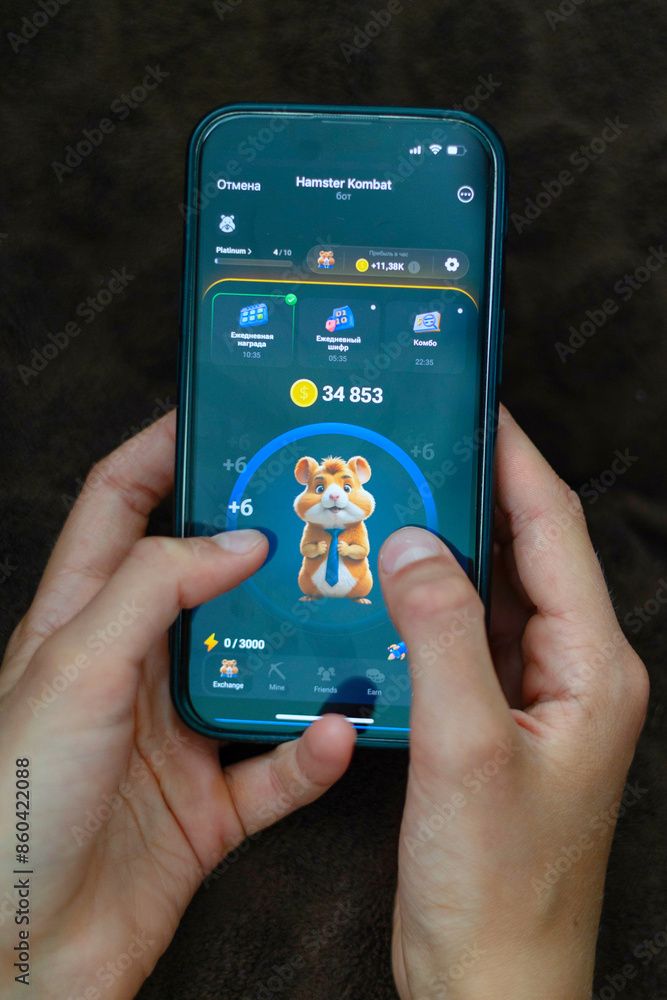 boy plays hamster kombat telegram bot on smartphone screen and earns ...