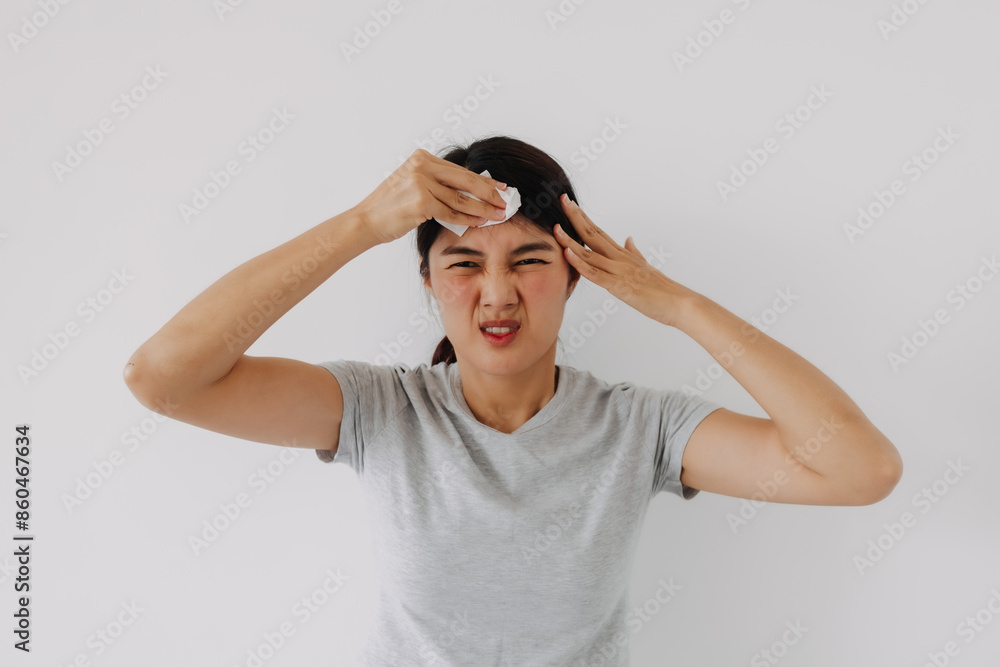 Asian Thai woman using tissue wiping her funny face, sweating in hot ...
