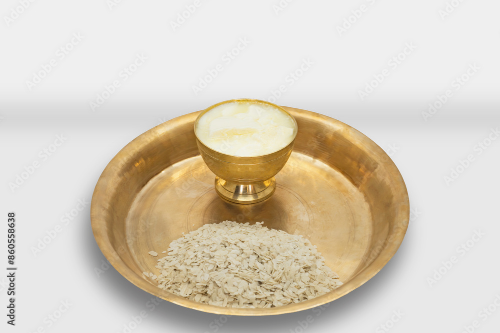 A copper plate and bowl of Dahi Chiura aka Yoghurt and Rice Flakes for ...