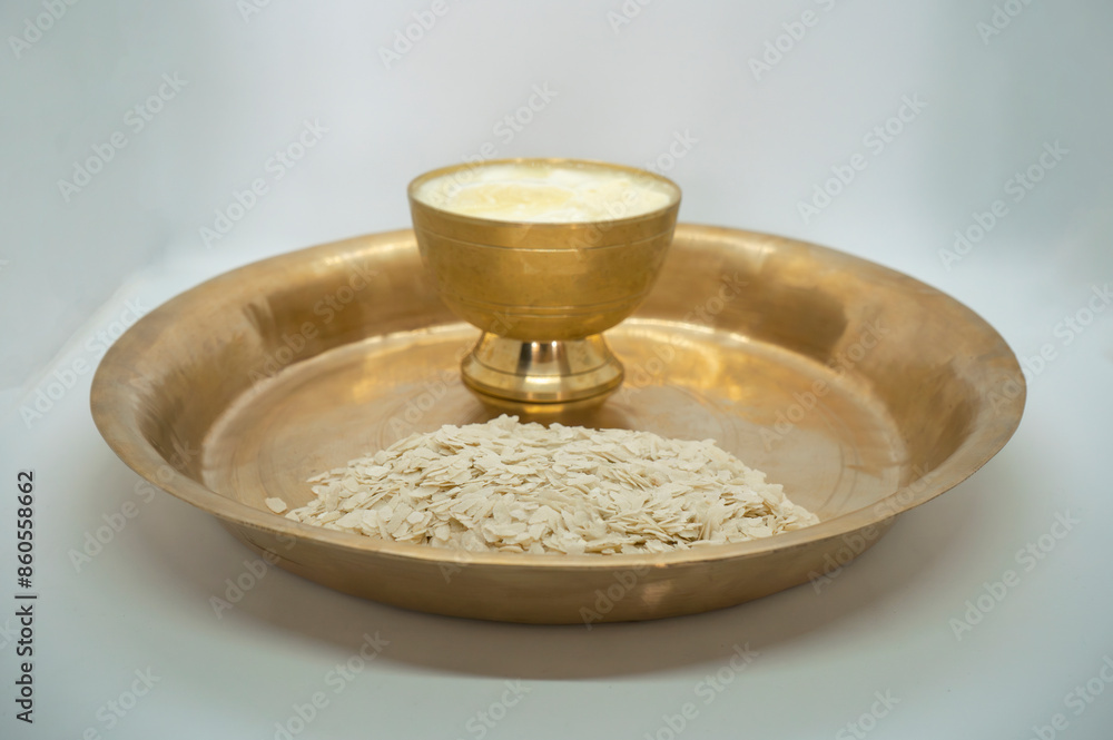 A copper plate and bowl of Dahi Chiura aka Yoghurt and Rice Flakes for ...