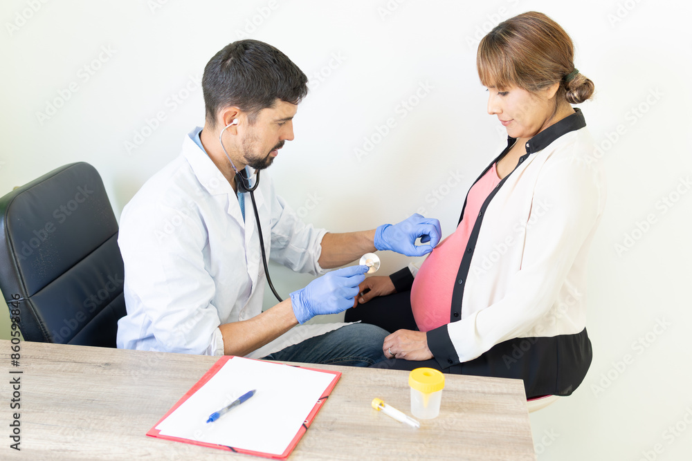Pregnant woman sitting on chair in clinic, big belly, visiting doctor ...