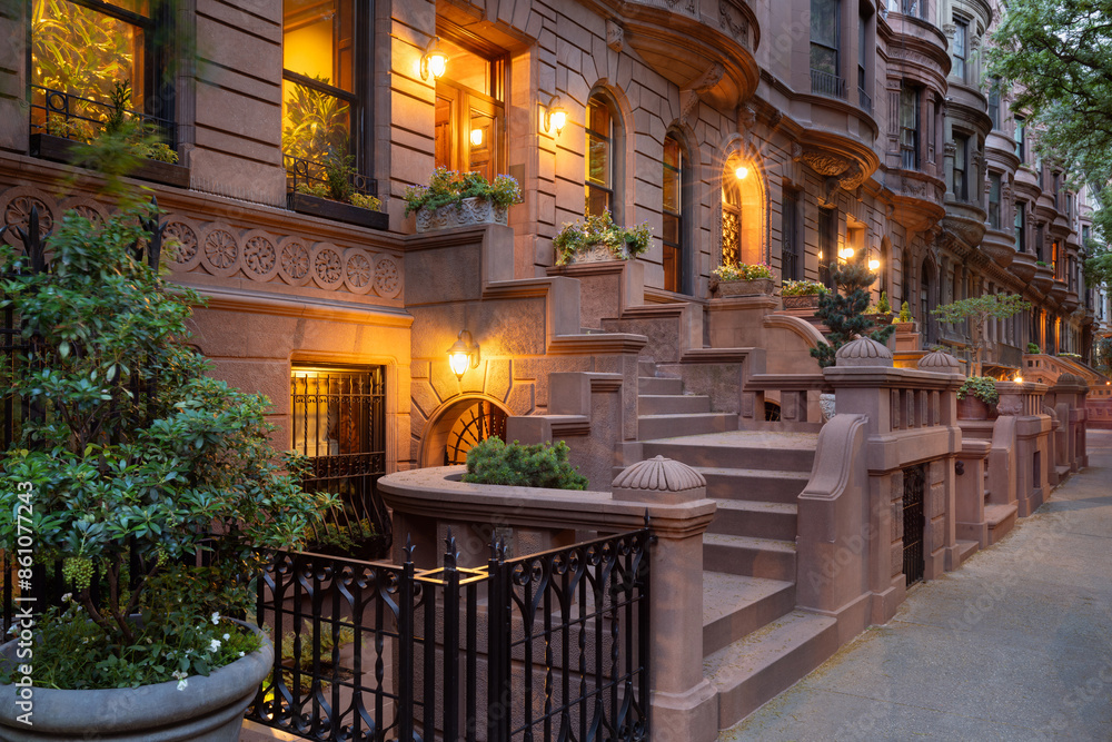 Evening view of iconic New York City brownstones with stoop steps on Upper West Side of ...