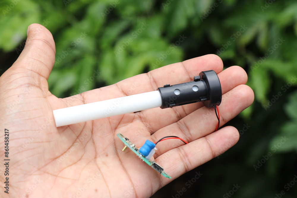 Humidifier spray module held in the hand isolated on natural background ...