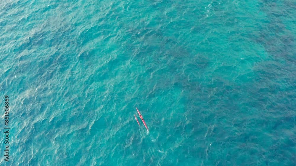 Outrigger Canoe rowing on turquoise blue sea in Hawaii overhead top ...