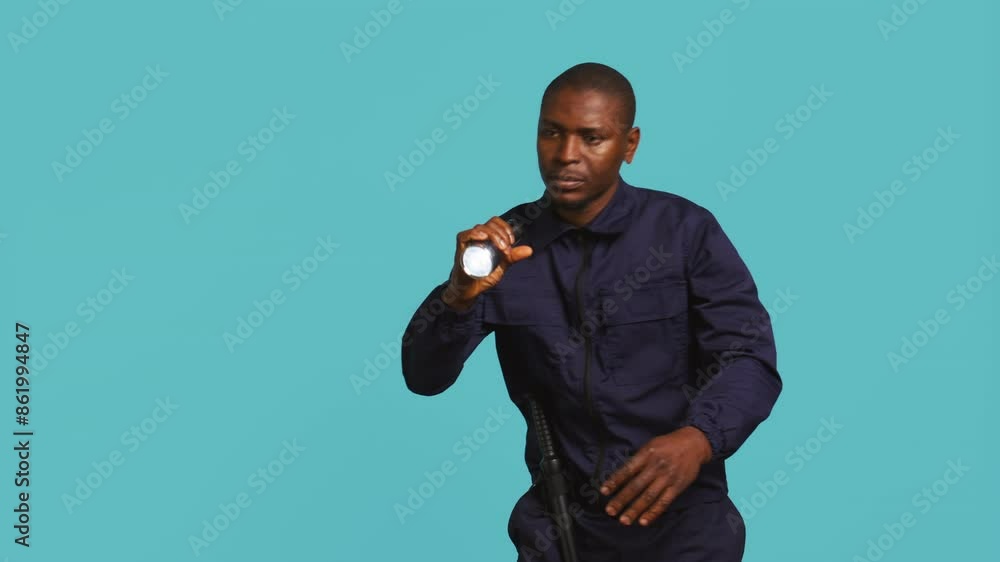 Security guard preventing criminal activity turning on flashlight after ...