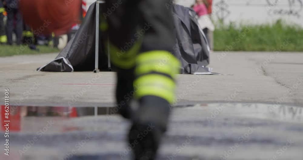 A reflective scene captures a firefighter heading into a dangerous ...