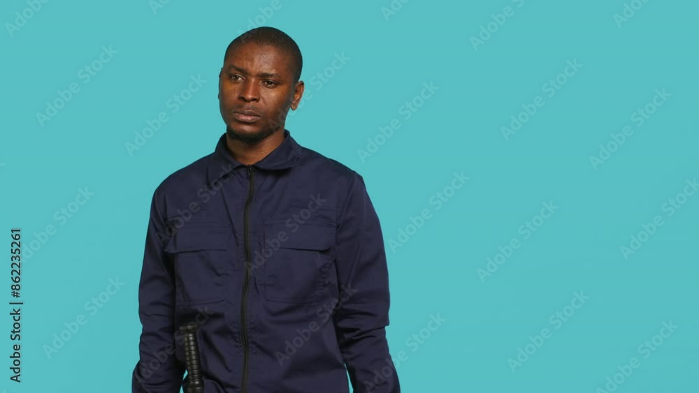 Security guard doing time out sign gesturing, being tasked with ceasing ...