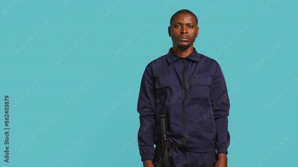 Security guard in threatening pose, tasked with preventing criminal ...
