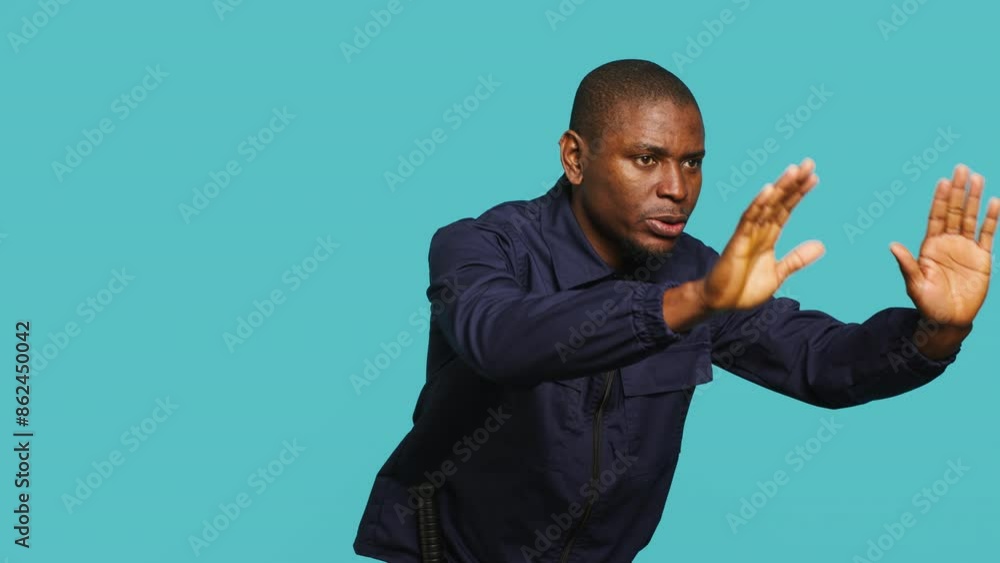 Security guard doing stop sign gesturing, being tasked with preventing ...