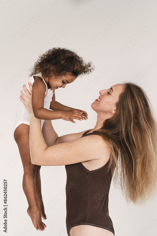Interracial family having fun on white background. Mixed marriages ...