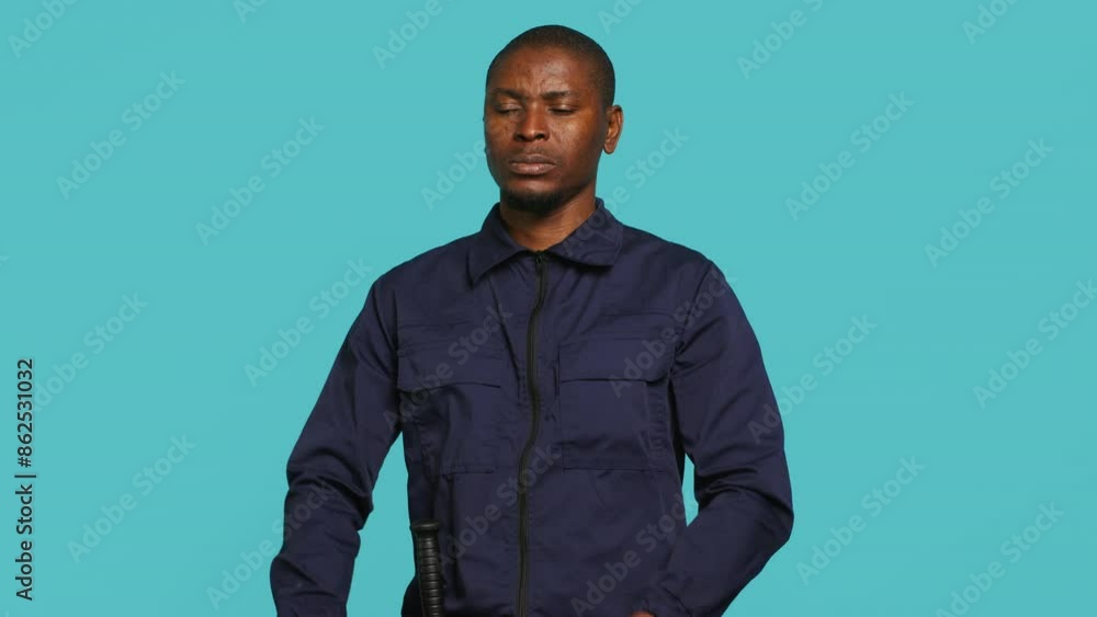 Security guard in threatening pose, tasked with preventing criminal ...